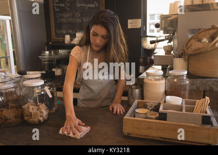 Waitress cleaning cafe counter Stock Photo - Alamy