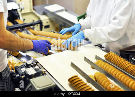 Production line with biscuits and factory workers Stock Photo, Royalty ...