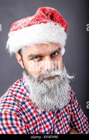 Christmas celebration. Serious Santa Claus with small fir-tree. Winter ...