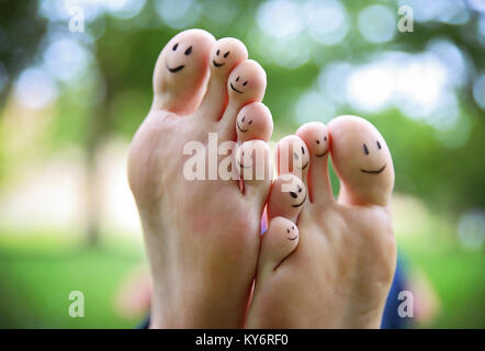 all ten toes of feet with smiley faces drawn with black pen Stock Photo ...