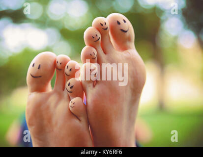all ten toes of feet with smiley faces drawn with black pen Stock Photo ...