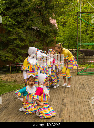 Cute little girl ballerina and her teacher doing exercises in ballet ...