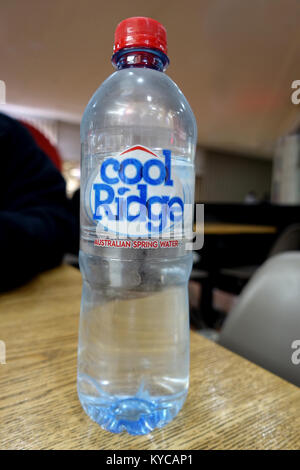 Bottled water on the wooden table, close up Stock Photo - Alamy