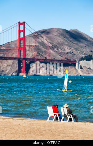 A scenic view of people relaxing at a sandy Travemunde Strand beach on ...
