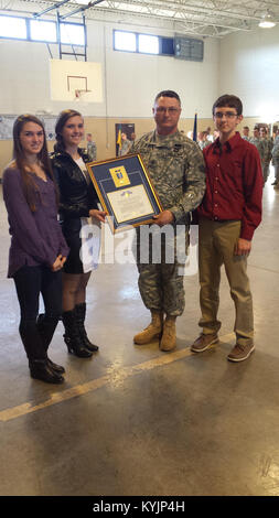 Command Sgt. Maj. Nathan Tolliver presents the NCO sword to Col. John ...