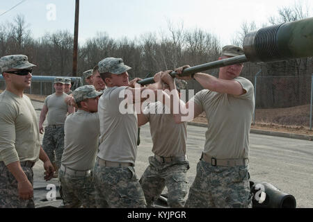 Soldiers with the 2nd Battalion, 138th Field Artillery maneuver a M109 ...
