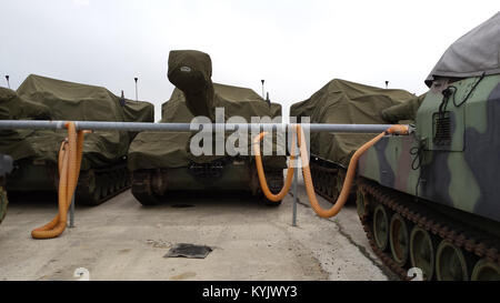 US Army National Guard tanks under protective air conditioned covers ...