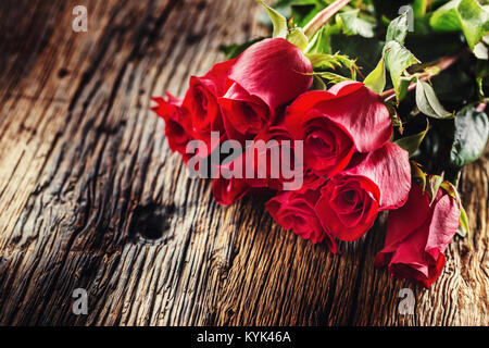 Red roses bouquet on rustic wooden background with copy space Stock ...