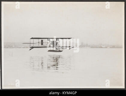 Curtiss Pusher floatplane in flight over San Diego Bay, captured in an ...