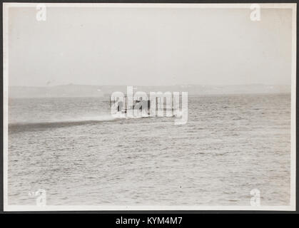 #A photograph of a Martin seaplane in flight, showcasing early aviation ...