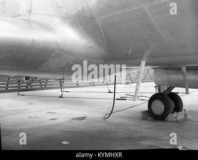 A negative photograph of a Convair aircraft, captured during a flight ...