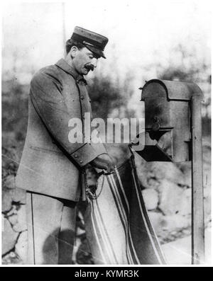 A historic photograph showing a letter carrier driving a Cushman ...