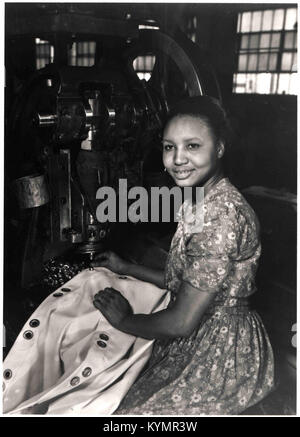 An African American woman repairing a mail sack at the U.S. Postal ...