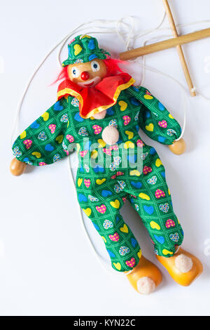 Clown puppet with strings set on white background Stock Photo - Alamy
