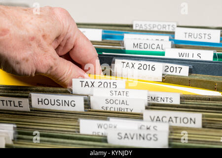 Home filing system for taxes organized in folders Stock Photo - Alamy