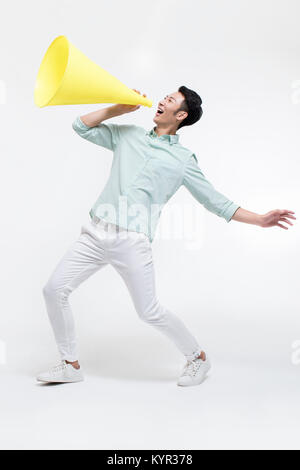 a man shouting through a megaphone Stock Photo - Alamy