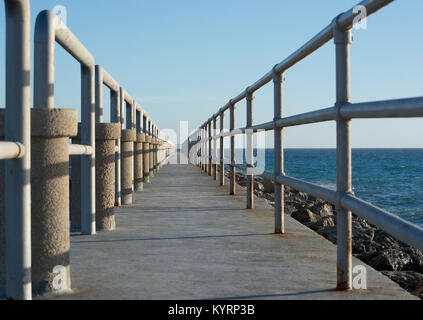 Pier structure with perspective towards the ocean horizon Stock Photo ...