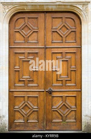 Ornate double front door with carved stonework facade Stock Photo ...