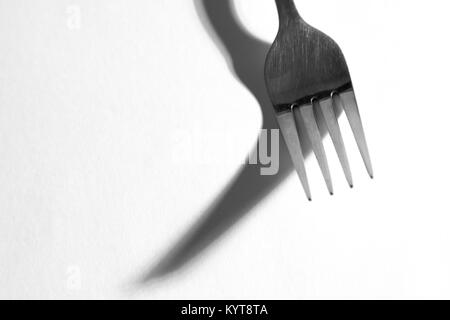 Fork isolated with creative shadow Stock Photo - Alamy