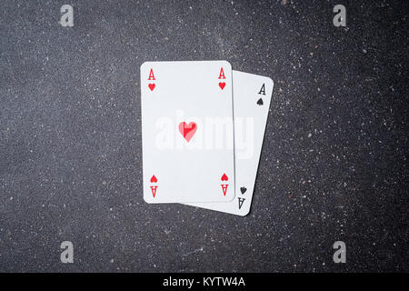 Two aces on gray stone background Stock Photo - Alamy
