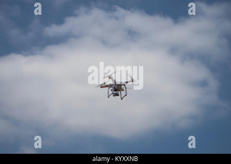 Low angle view of quadcopter against cloudy sky Stock Photo - Alamy