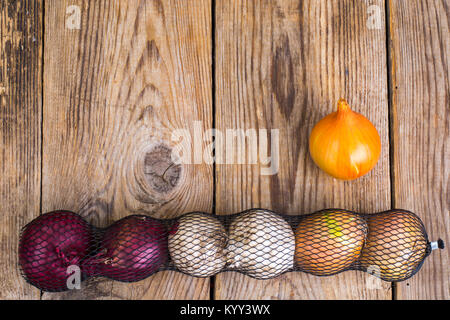 Onion in net for storage. Studio photo Stock Photo - Alamy