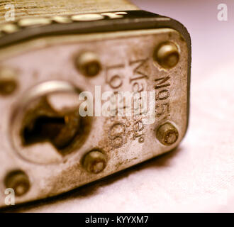 Close-up of Master Lock key lockbox attached to metal fence with green ...