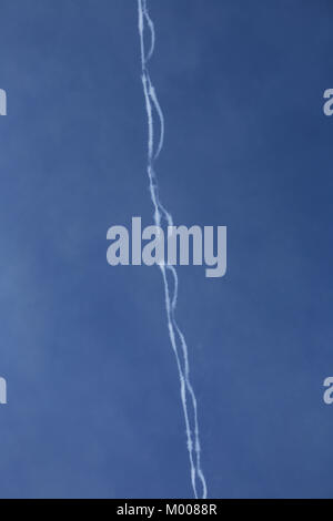 Jet trails against a blue sky Stock Photo - Alamy
