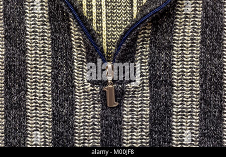 Background, texture, zipper sewn into woolen fabric with vertical ...