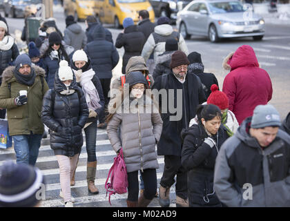 Pedestrians bundled up for cold weather walk in Manhattan in below ...