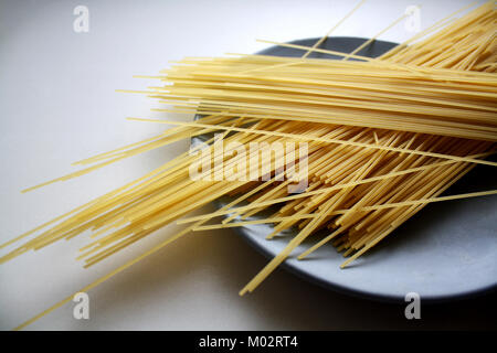 Stack of spaghetti isolated on grey concrete plate from a high angle ...