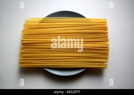 Spaghetti stack isolated on grey concrete plate Stock Photo - Alamy