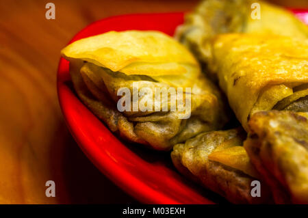 Thin rolled pancakes stuffed with mushrooms, pan-fried Stock Photo - Alamy