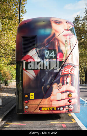 Coca-Cola advertising sign on bus stop at dusk, Warren Street, London ...