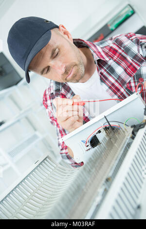 young man repairing radiator Stock Photo - Alamy