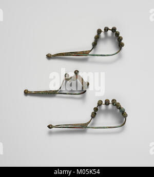 The bronze fibula, an ancient safety pin with four rings, is a ...