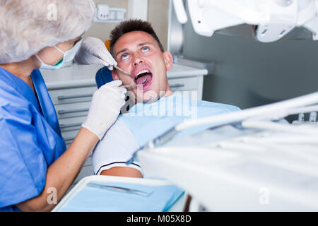 Young man visiting dentist, taking care of his health and dental ...
