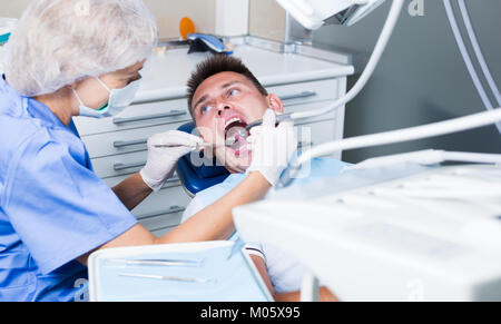 Young man visiting dentist, taking care of his health and dental ...