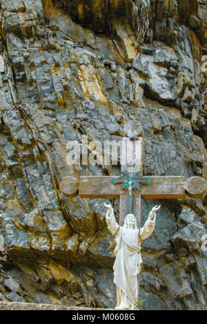 Stone statue of Jesus Christ pointing at His Sacred Heart on a ...