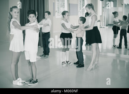 Group of diligent friendly children dancing tango in dance studio Stock ...