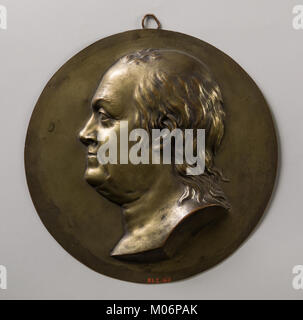 This medallion features intricate designs, likely depicting historical ...