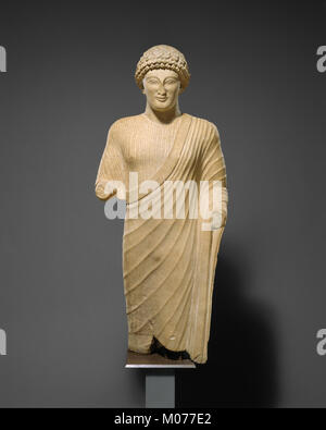 This limestone sculpture depicts a youthful figure, showcasing the ...