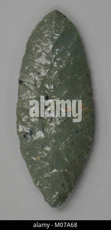 This obsidian blade, made from volcanic glass, exemplifies prehistoric ...