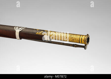 This 17th-century matchlock gun exemplifies early firearm technology ...