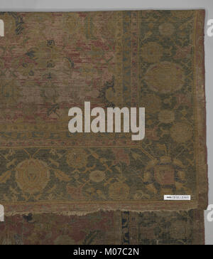 An Indo-Persian carpet with detailed vine scroll and palmette patterns ...