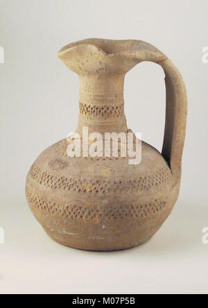 This jug is a ceramic vessel featuring a classic design, crafted for ...