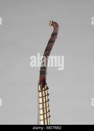 This mandolin, a stringed musical instrument, features intricate design ...