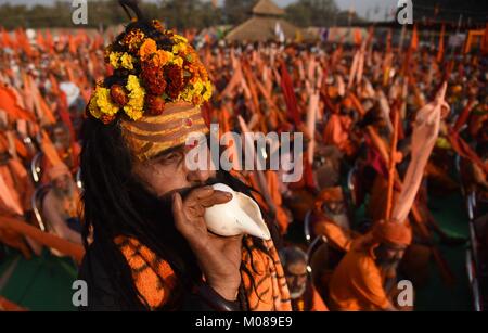 A Sadhu blowing a conch shell in front of Patteeswarar Swamy Temple at ...