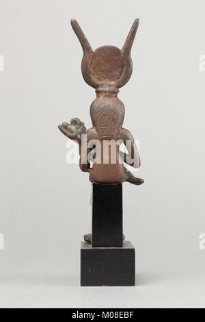 This depiction of Isis with her son Horus shows Egyptian iconography ...