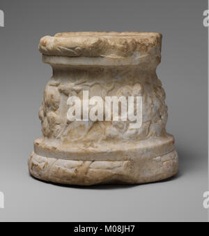 This marble round altar features a frieze with animals and masks ...